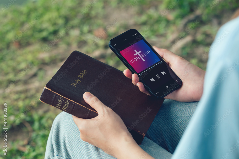 Women holding mobile phones praying worship to GOD with church online ...