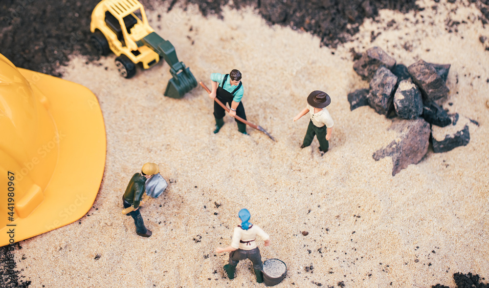 Top view, Teamwork miniature engineering man talking and digger on the ...