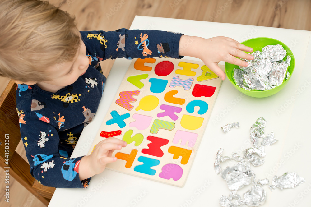 Two year boy playing with wooden alphabet letters board. Letters ...