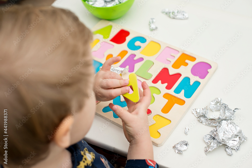Two year boy playing with wooden alphabet letters board. Letters ...
