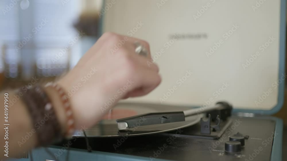 Close-up of hand putting record in vinyl player. Action. Man puts ...