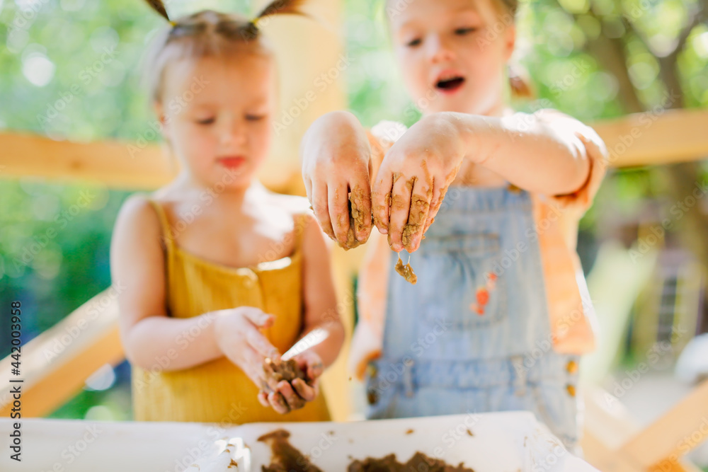 Photo & Art Print Happy children play with sand and water in sensory ...