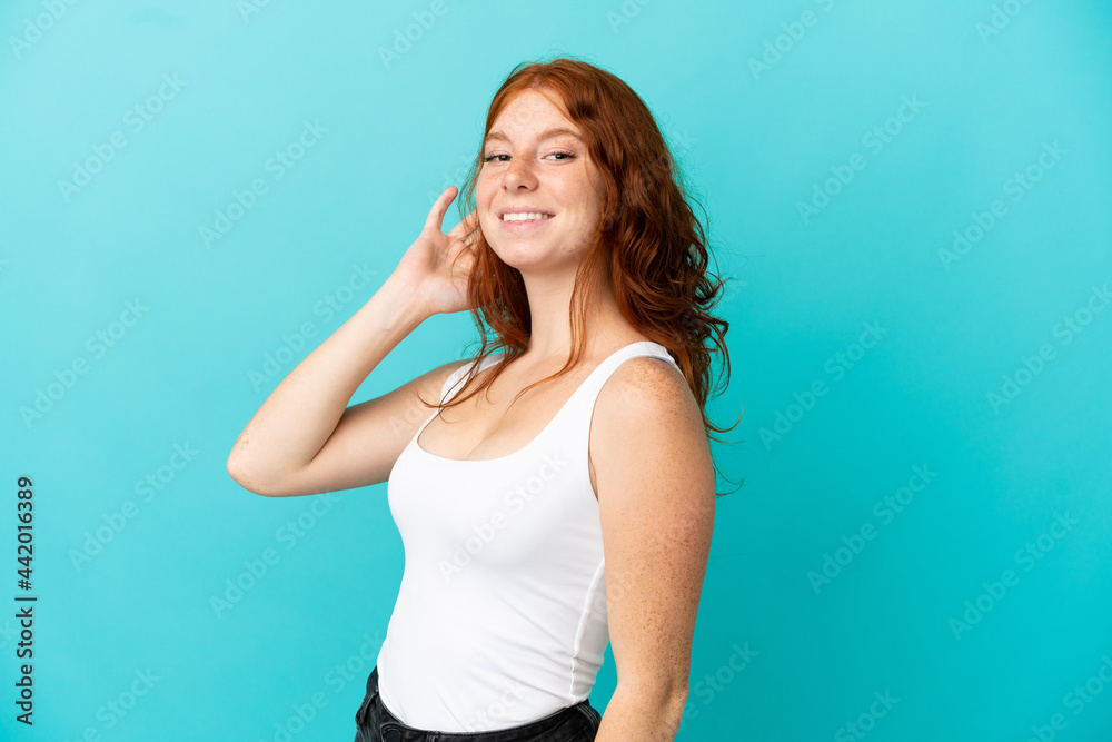 Teenager redhead girl isolated on blue background in swimsuit in summer ...