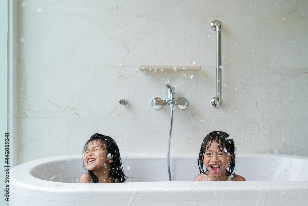 two happy asian girl taking a bath together on a bathtub Stock Photo ...