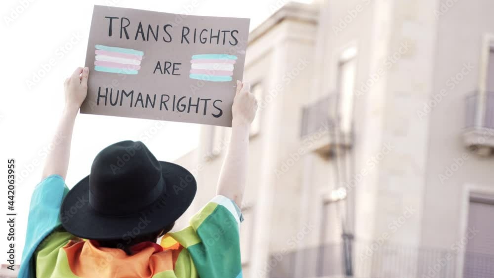 Transgender people at gay pride holding trans human rights flag banner ...