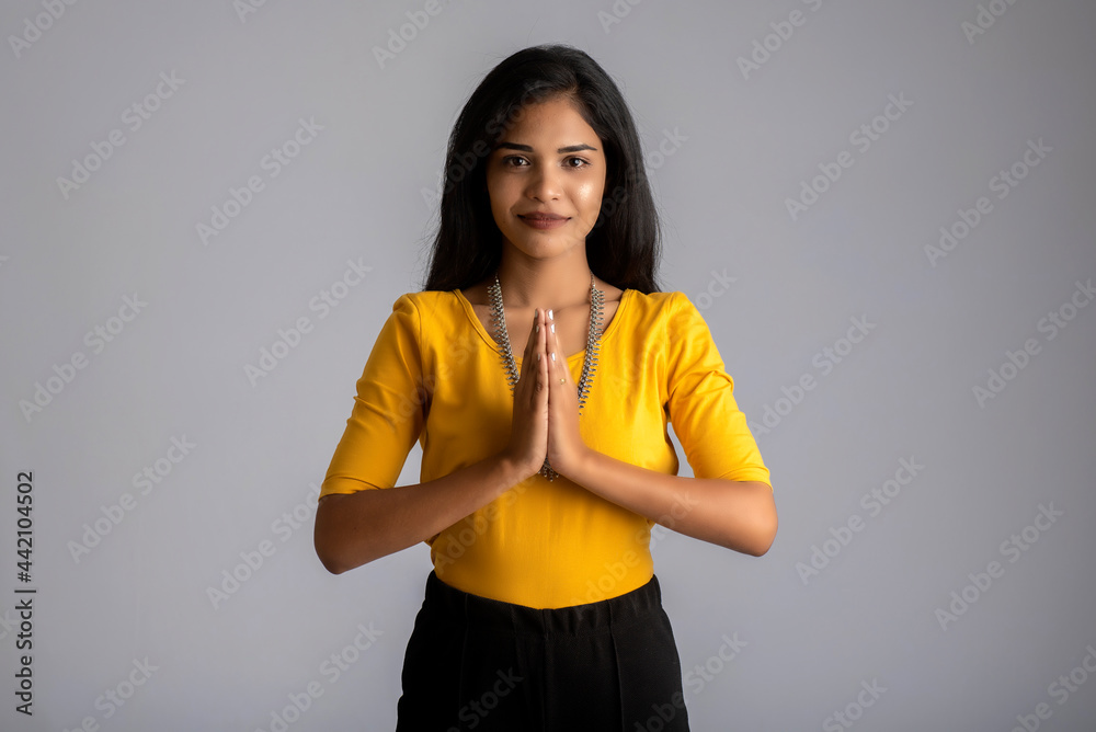 Beautiful Indian girl with welcome expression or inviting or greeting ...