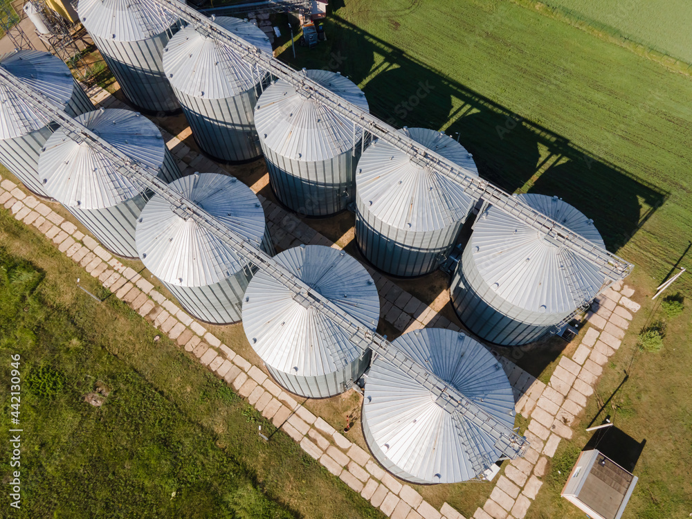 Metal grain elevator in agricultural zone. Towers of grain drying ...