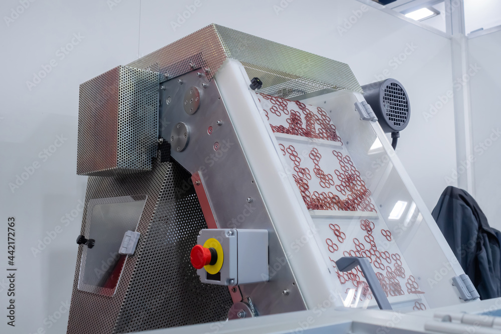 Plastic details moving on conveyor belt of automatic injection molding ...