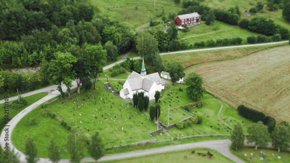 An aerial view of a beautiful miniature cross-shaped church with a ...