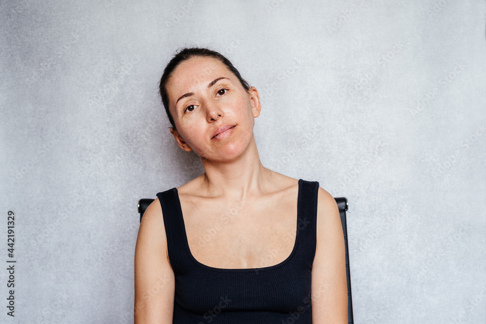 McKenzie method exercise to relieve neck pain, a woman gently rotates ...