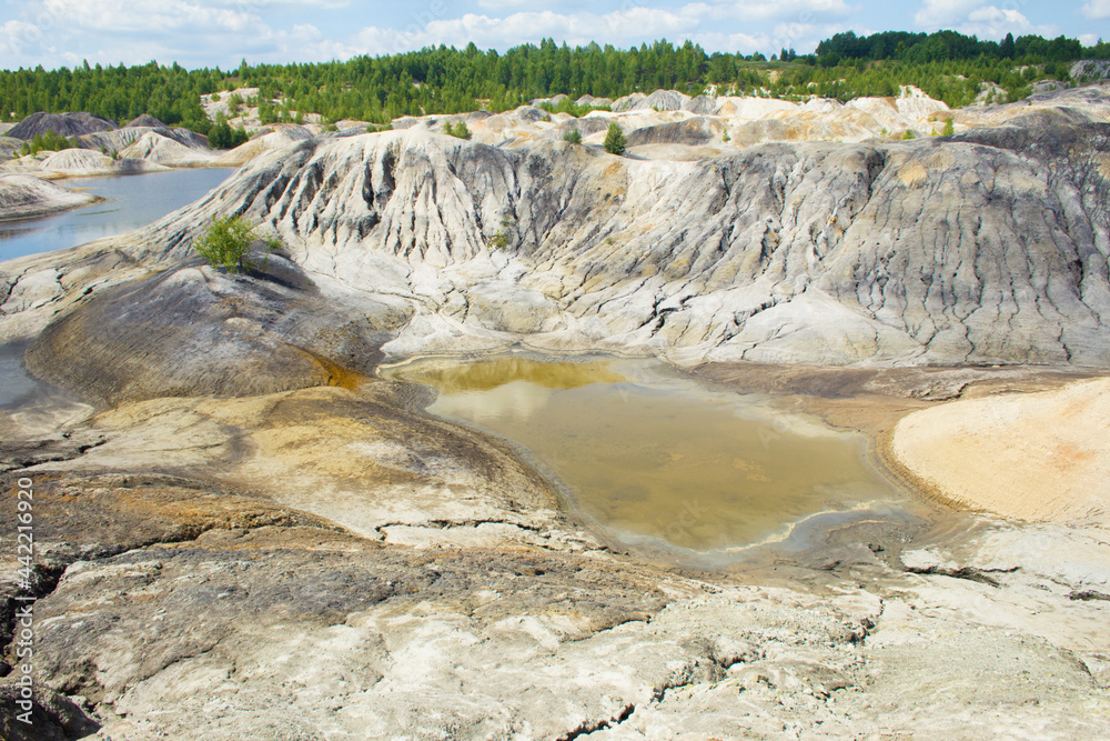A poisonous, acidic lake in the middle of colorful, lifeless clay hills ...