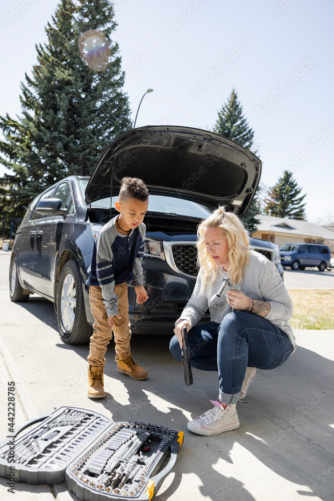 Mother and son selecting tool from toolbox in driveway Stock Photo ... Mother and son selecting tool from toolbox in driveway Stock Photo ...