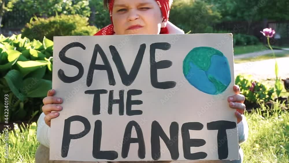 Young kid child holding in hands green posters at global climate strike ...