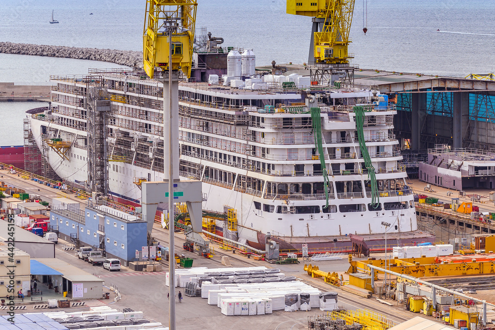 Cruise ship under construction close up, crane working to assemble the ...
