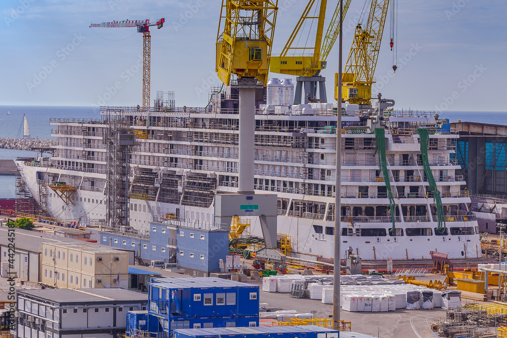 Cruise ship under construction close up, crane working to assemble the ...