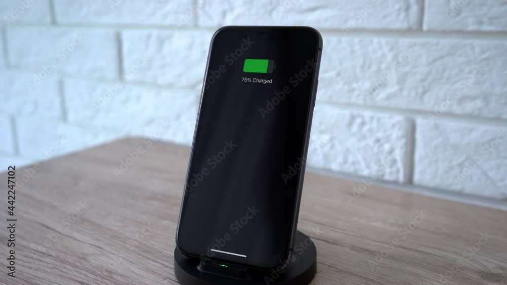 Process of mobile phone charging on an induction station pad. 4k stock ...