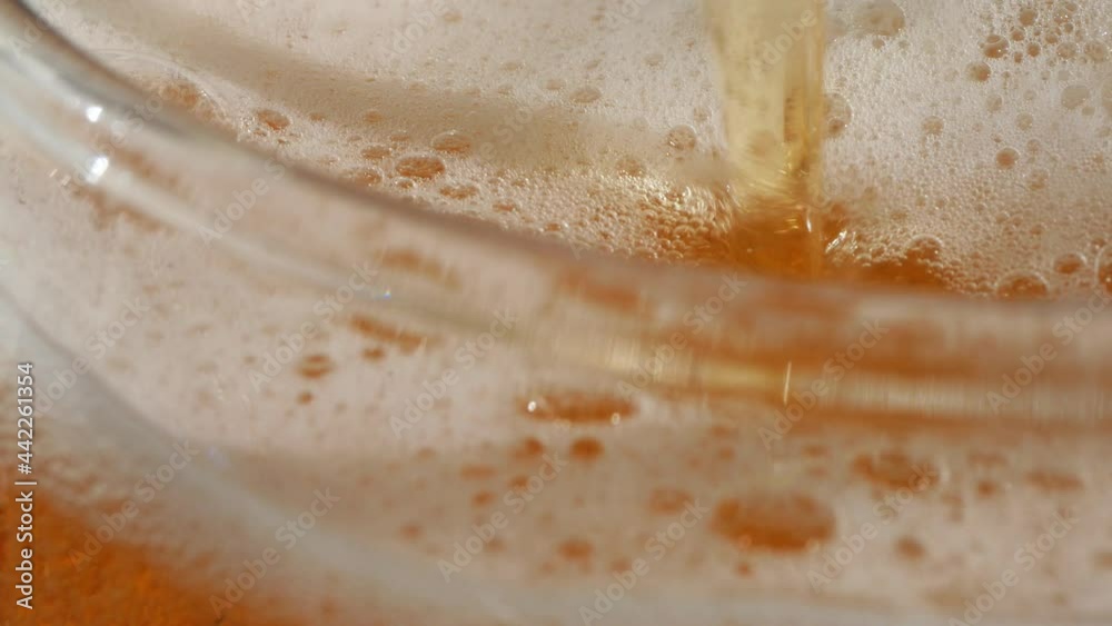 More beer is being poured into beer glass, and as it fills up the ...
