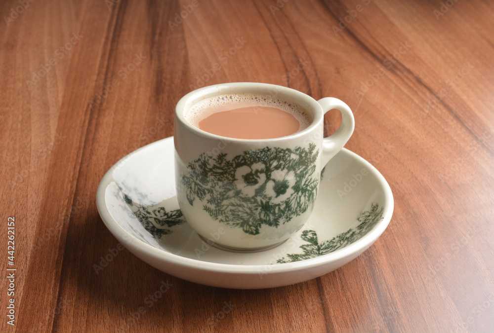 hot milk tea local Indian traditional teh Tarik in small cup on wood ...