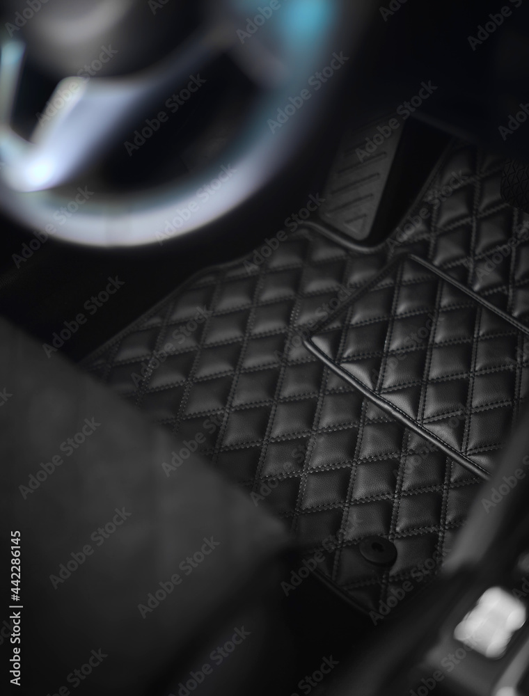 driver seat in the modern luxury car. luxury leather black floor mat ...