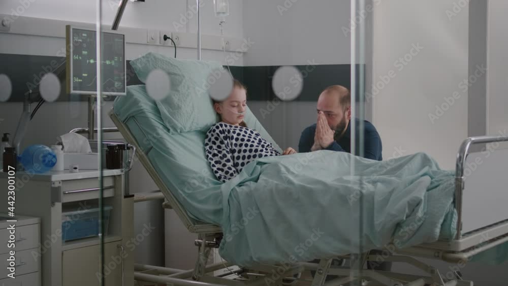 In hospital ward sick girl patient sleeping while worried father ...