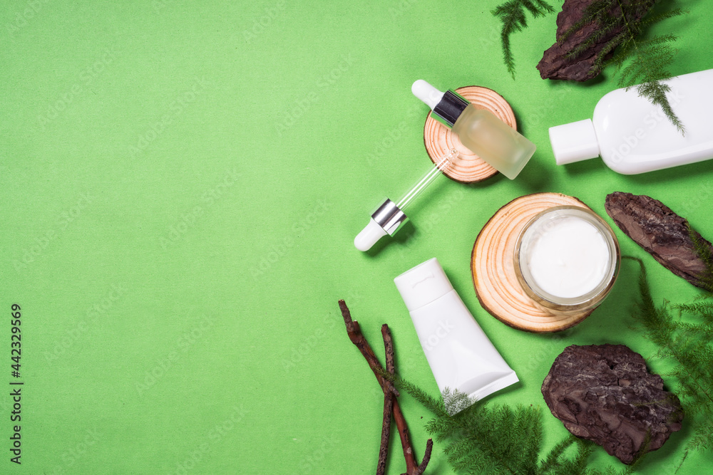 Natural Cosmetic products. Cream, serum bottle and green plants with ...