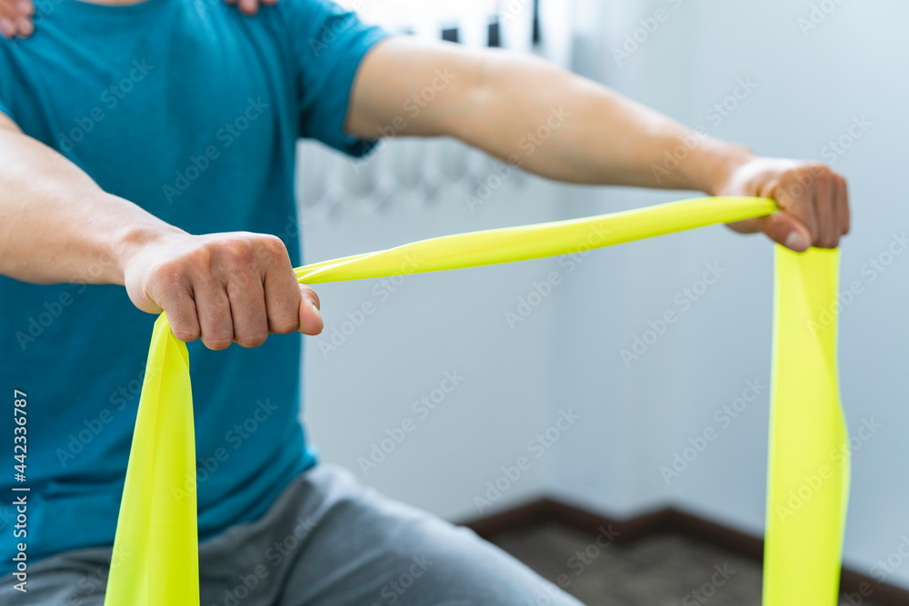 Physical therapist gives resistance band exercises. About the arms and ...