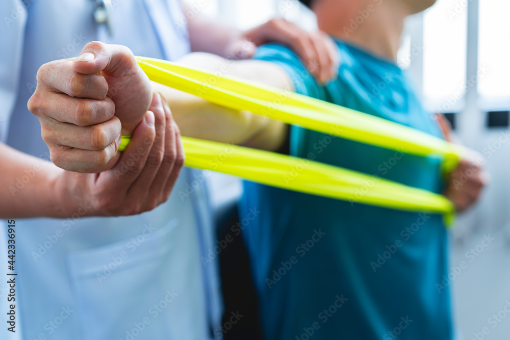 Physical therapist gives resistance band exercises. About the arms and ...