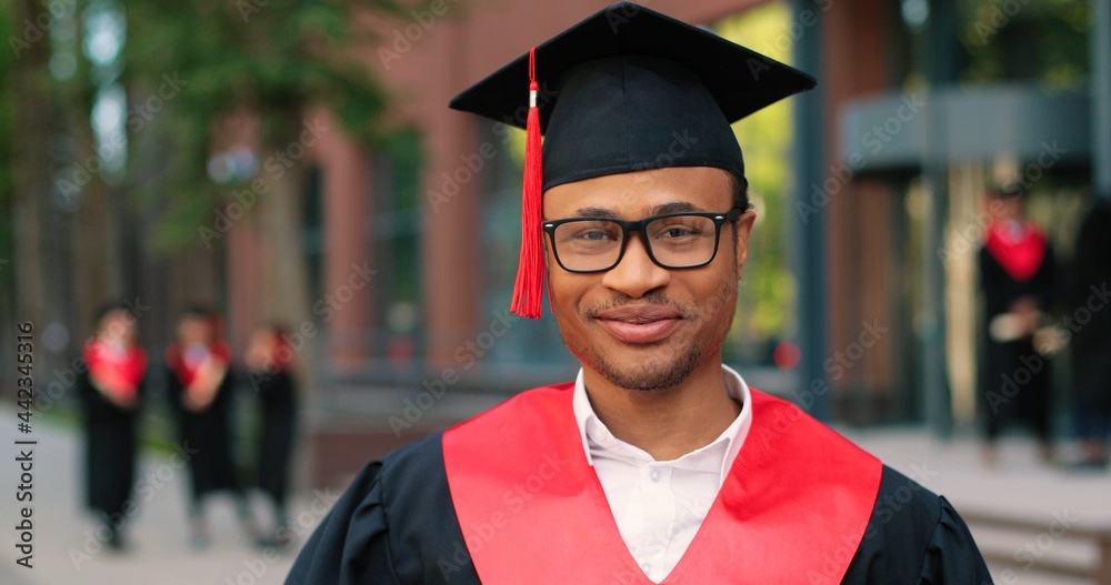 Young graduated boy holding his graduation degree convocation ceremony ...