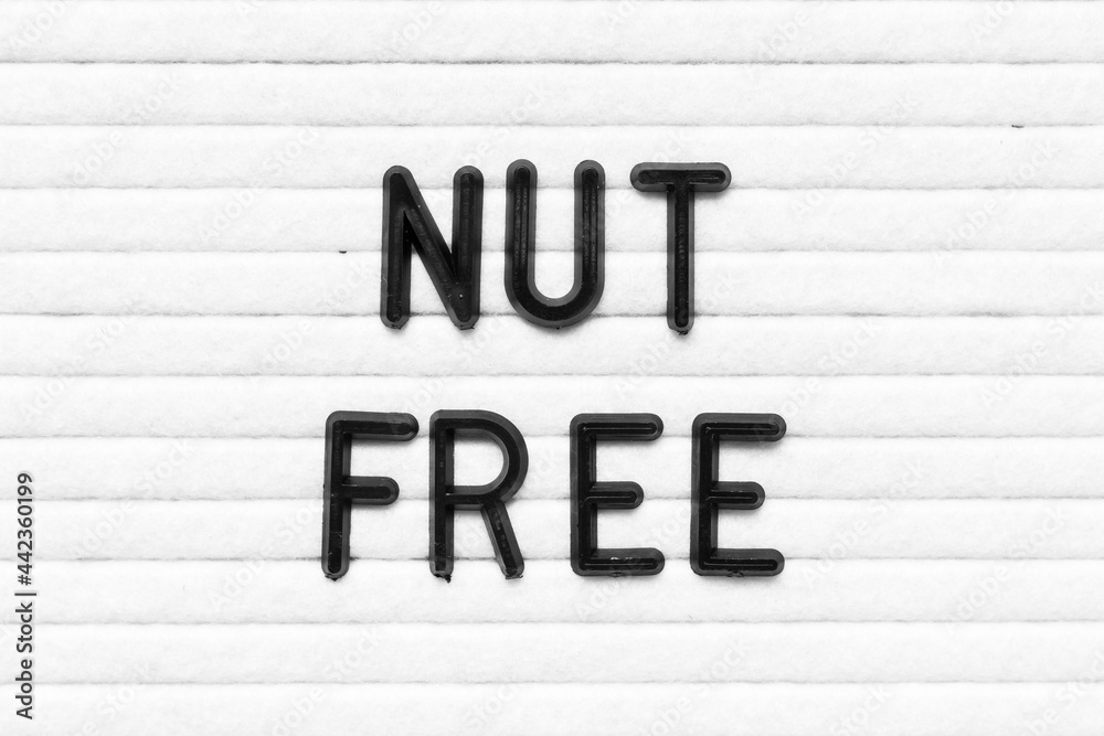 Black alphabet letter in word nut free on white felt board background ...