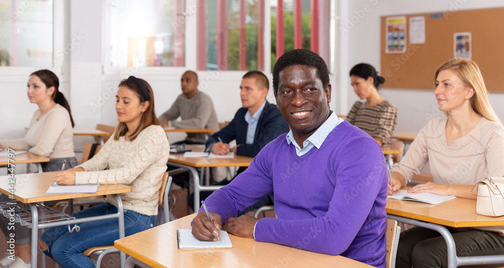 African-american student among students in university classroom Stock ...