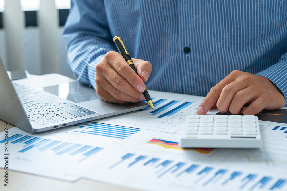 Close up account man hand using calculator for calculate and writing ...