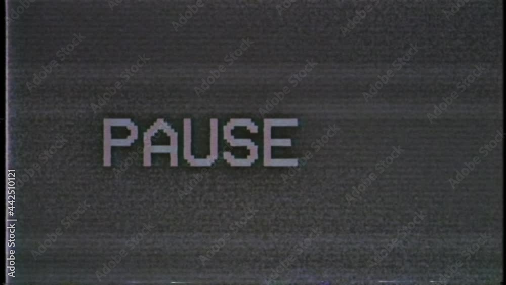 Old damaged VHS tape playing with PAUSE text message on screen, retro ...