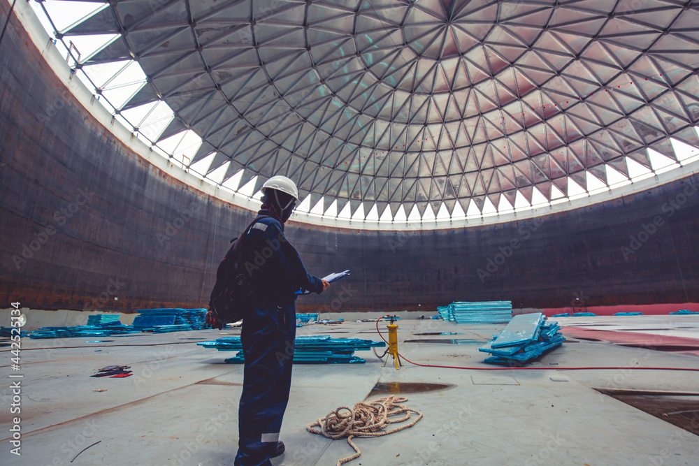 Male worker file record visual inspection tank into the confined space ...