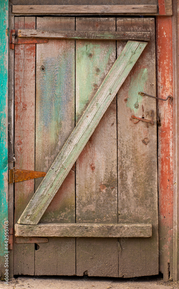 Old wooden door with the letter Z outside. Entrance to an old building ...