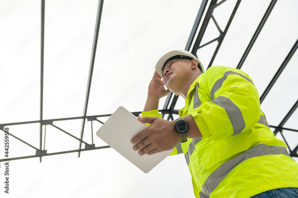Inspector civil engineer wearing safety helmet and holding tablet ...