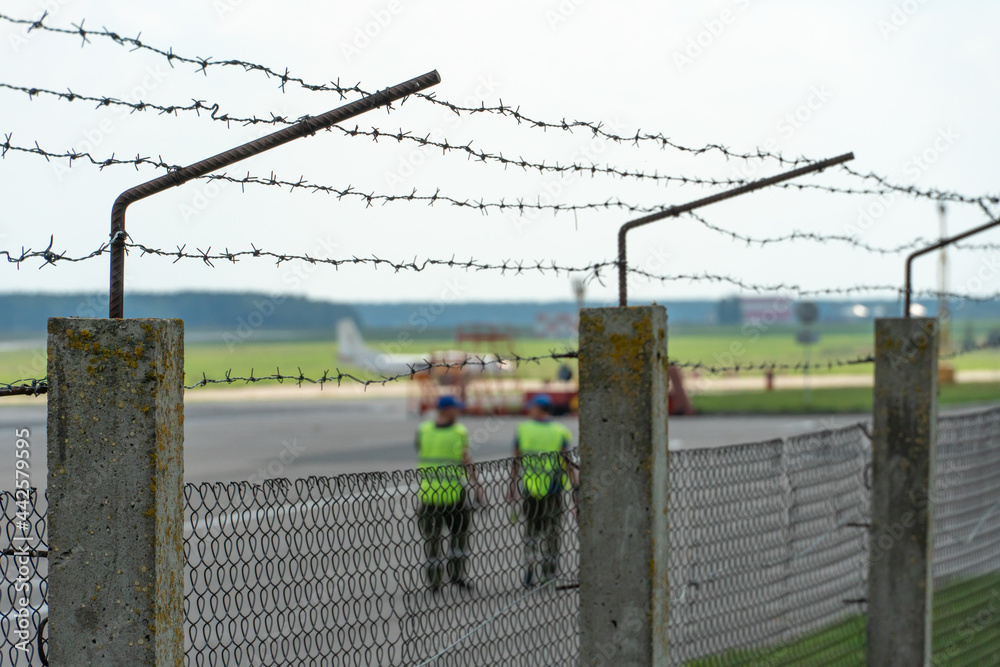 Airport employees are on the runway. The territory of the private ...