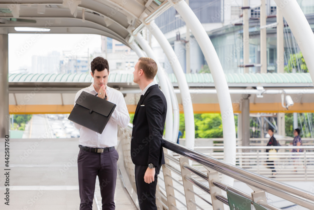 The new employee is raising his hand to say hello to the boss. Stock ...