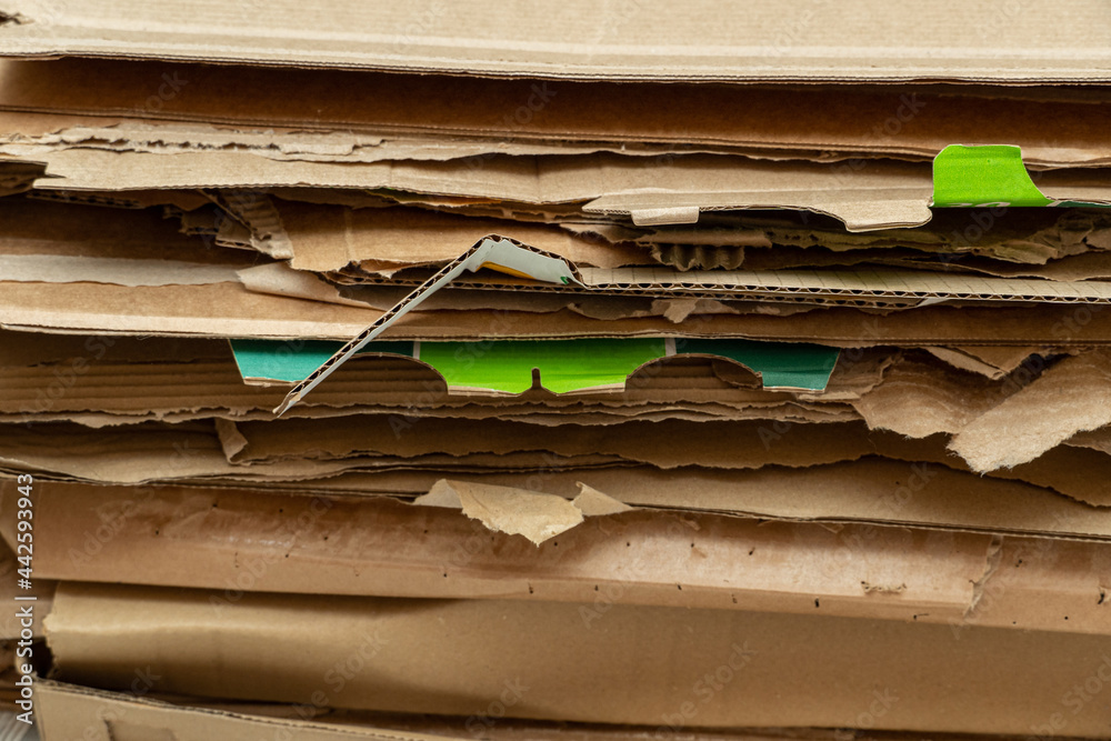 Many torn cardboard boxes assembled in a bundle, stack for recycling ...