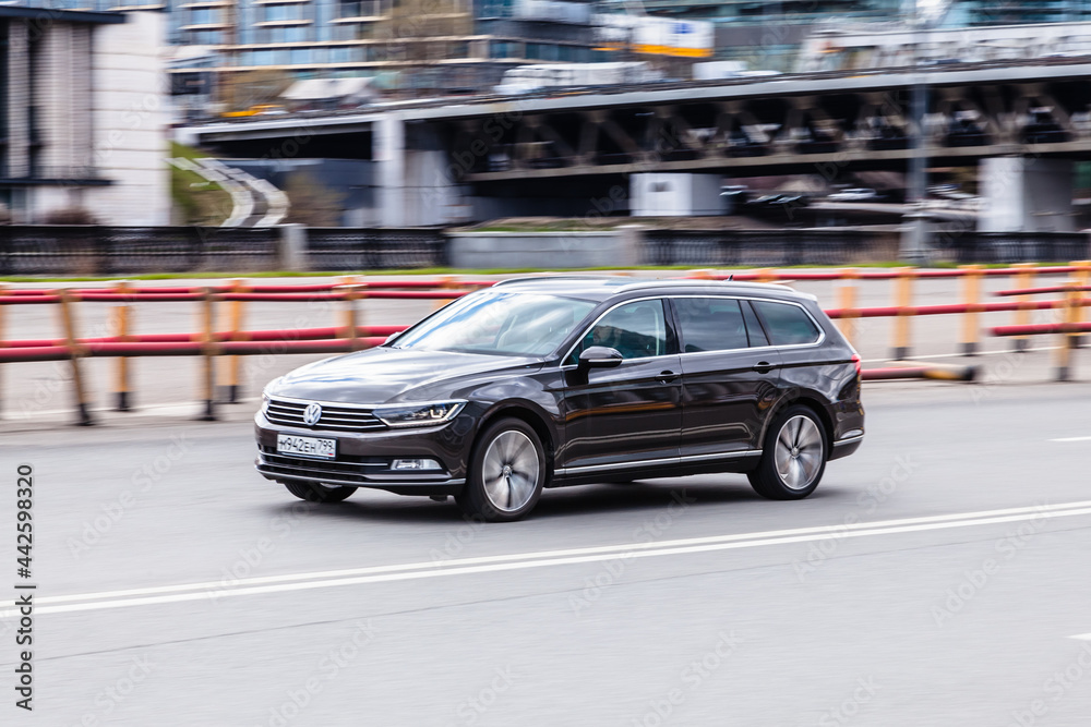VW estate driving fast motion on the highway, front side view. Black ...