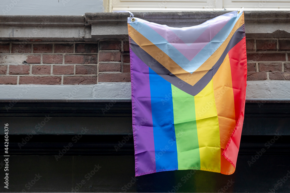 Progress pride flag (new design of rainbow flag) waving in the air with ...