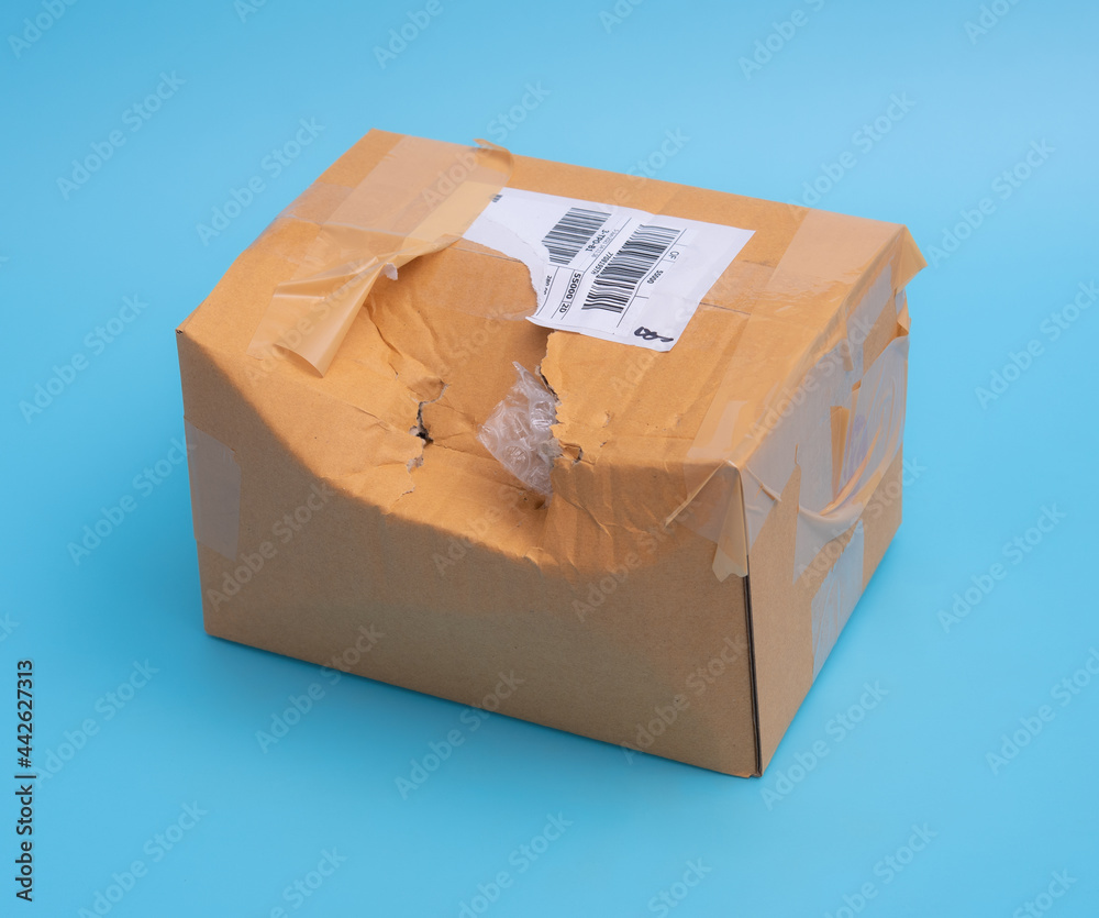 Damaged cardboard box with hole on blue background,cardboard box ...