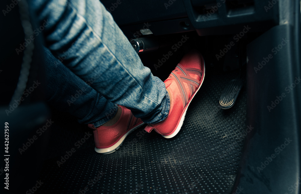 Her feet stepped on the brakes inside the car Stock Photo | Adobe Stock