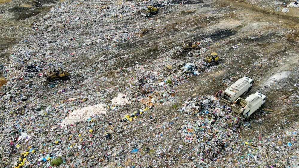 Landfill Dozer during working rubbish at garbage. Waste conservation ...