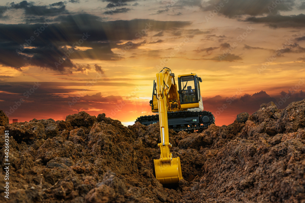 Yellow Excavators are digging the soil in the construction site on the ...