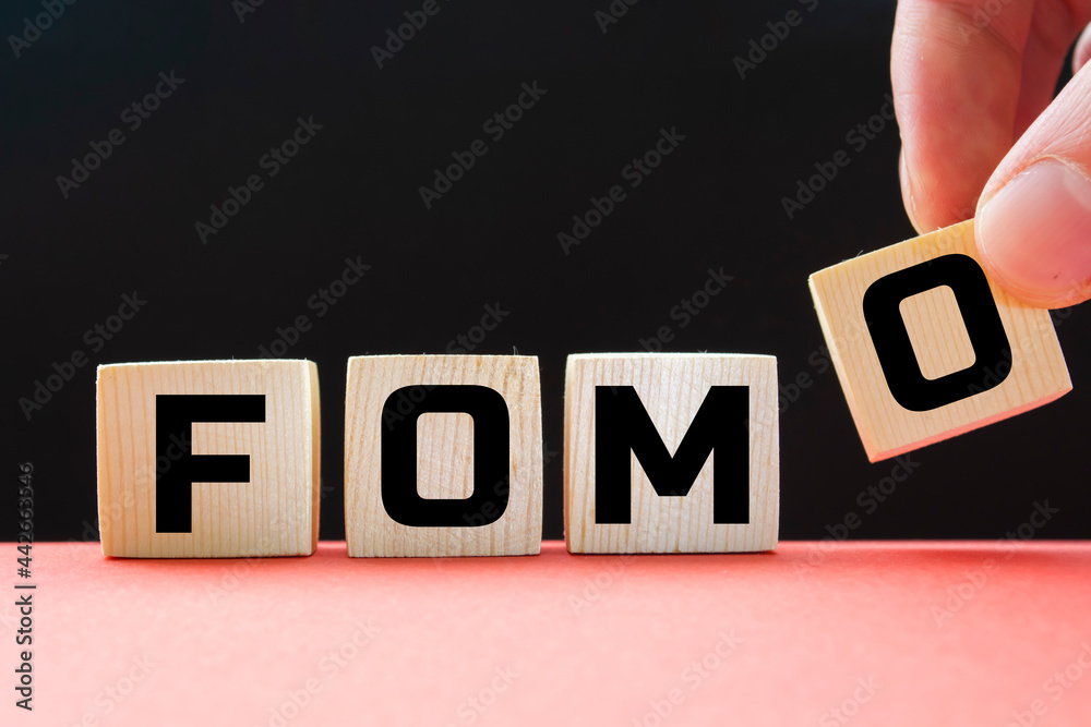 FOMO, acronym for Fear of Missing Out in wooden alphabet letters ...