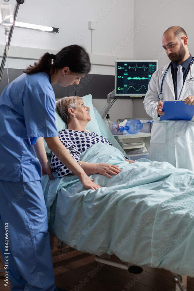 Nurse reading blood oxygen saturation from oxymeter device attached on ...
