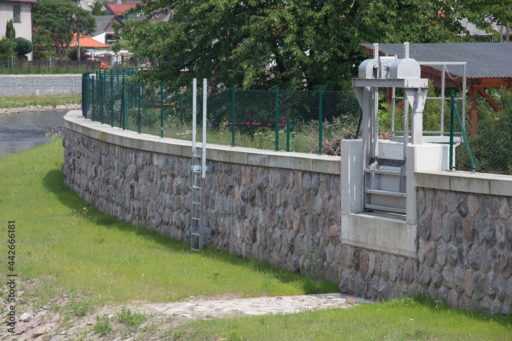 Modern flood protection wall in the style of the historic city wall ...