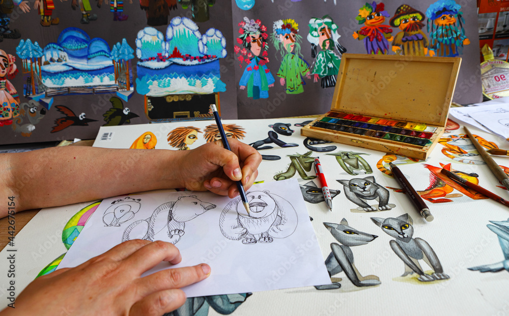 The animator draws with a pencil and draws characters from cartoons ...