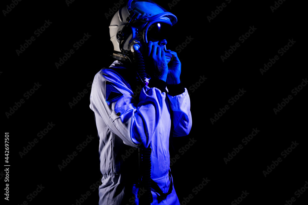 Astronaut in space suit standing in blue neon light Stock Photo | Adobe ...