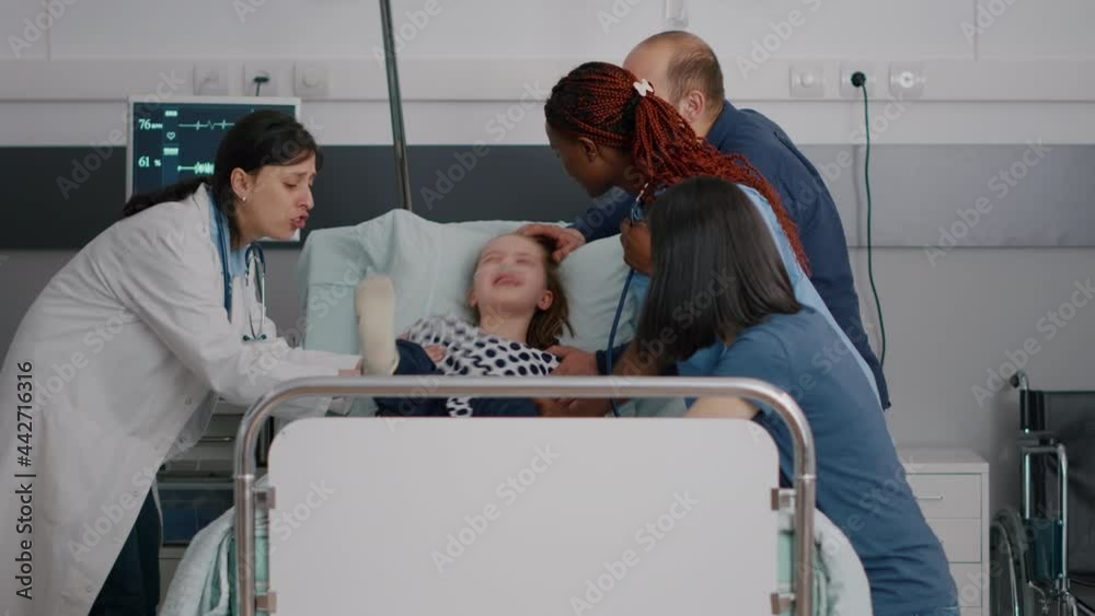 Hospitalized sick child suffering pain attack while medical team ...